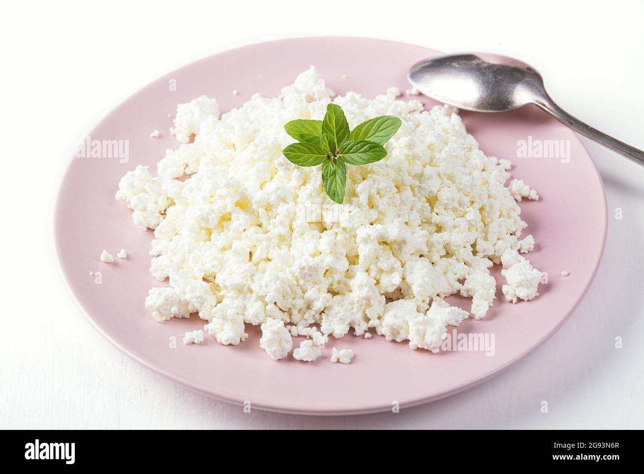 Cottage cheese in a pink plate isolated on a white background Stock ...