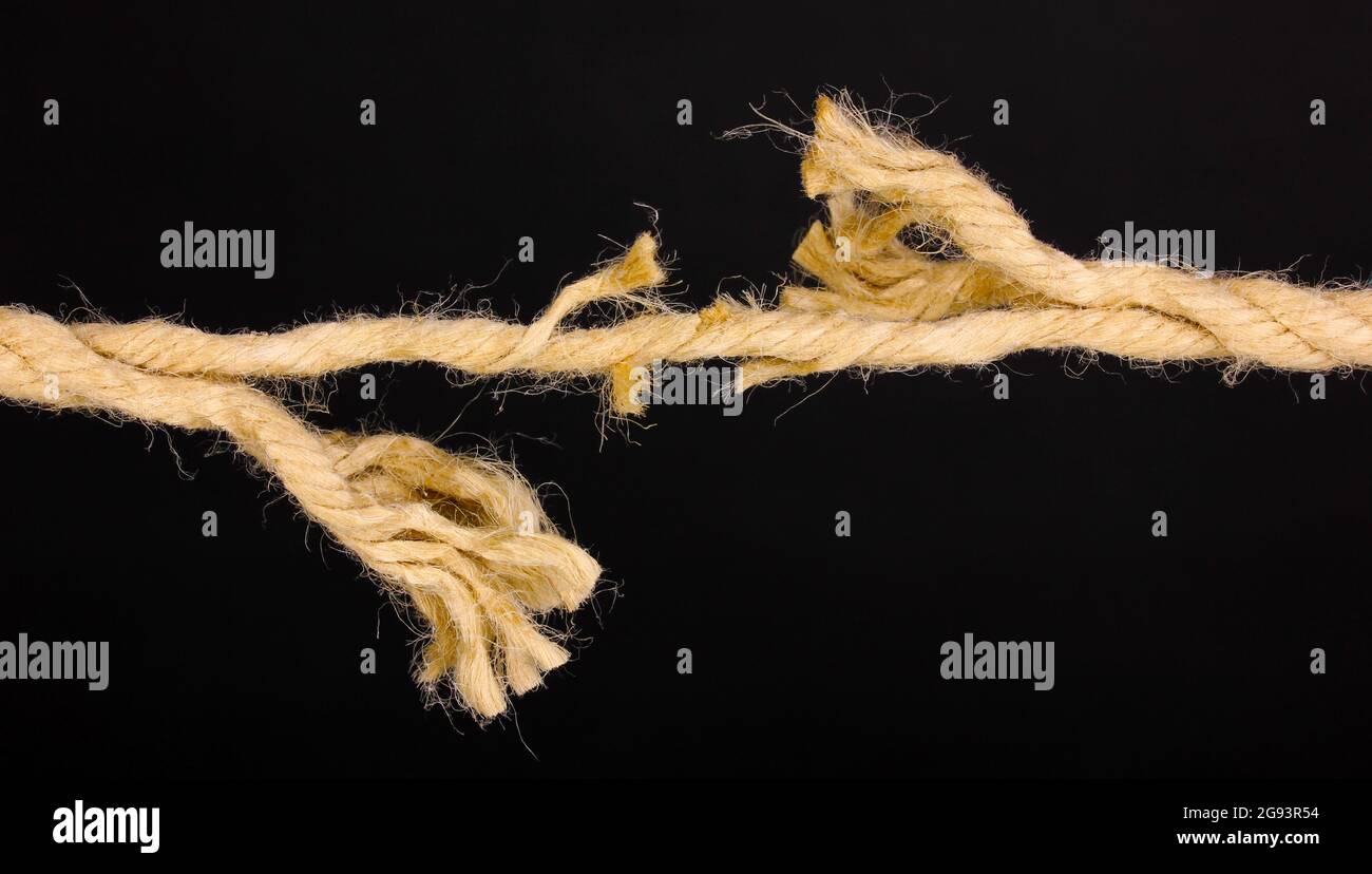 Breaking rope isolated on black Stock Photo - Alamy