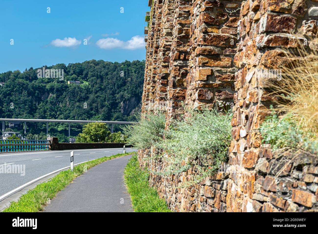 Walls made of red stone standing by the road to protect the roadside ...