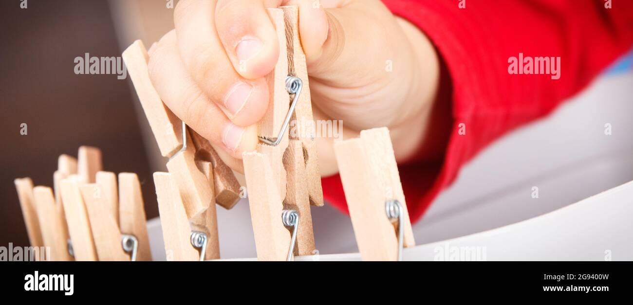 Preschooler playing with wooden clip. Development of kids motor skills ...
