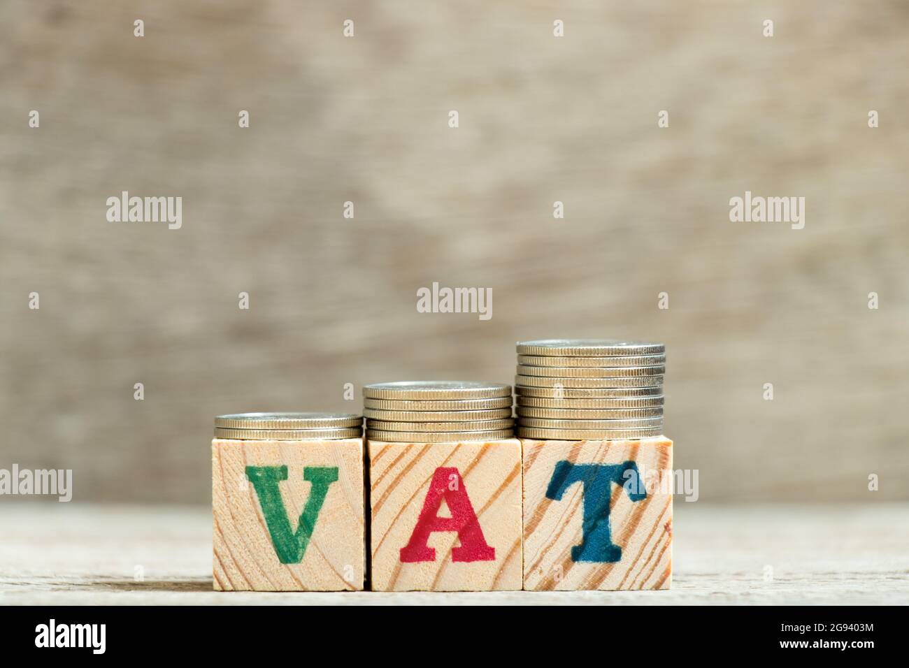Block in word VAT (Abbreviation of Value added tax) with coin in up ...