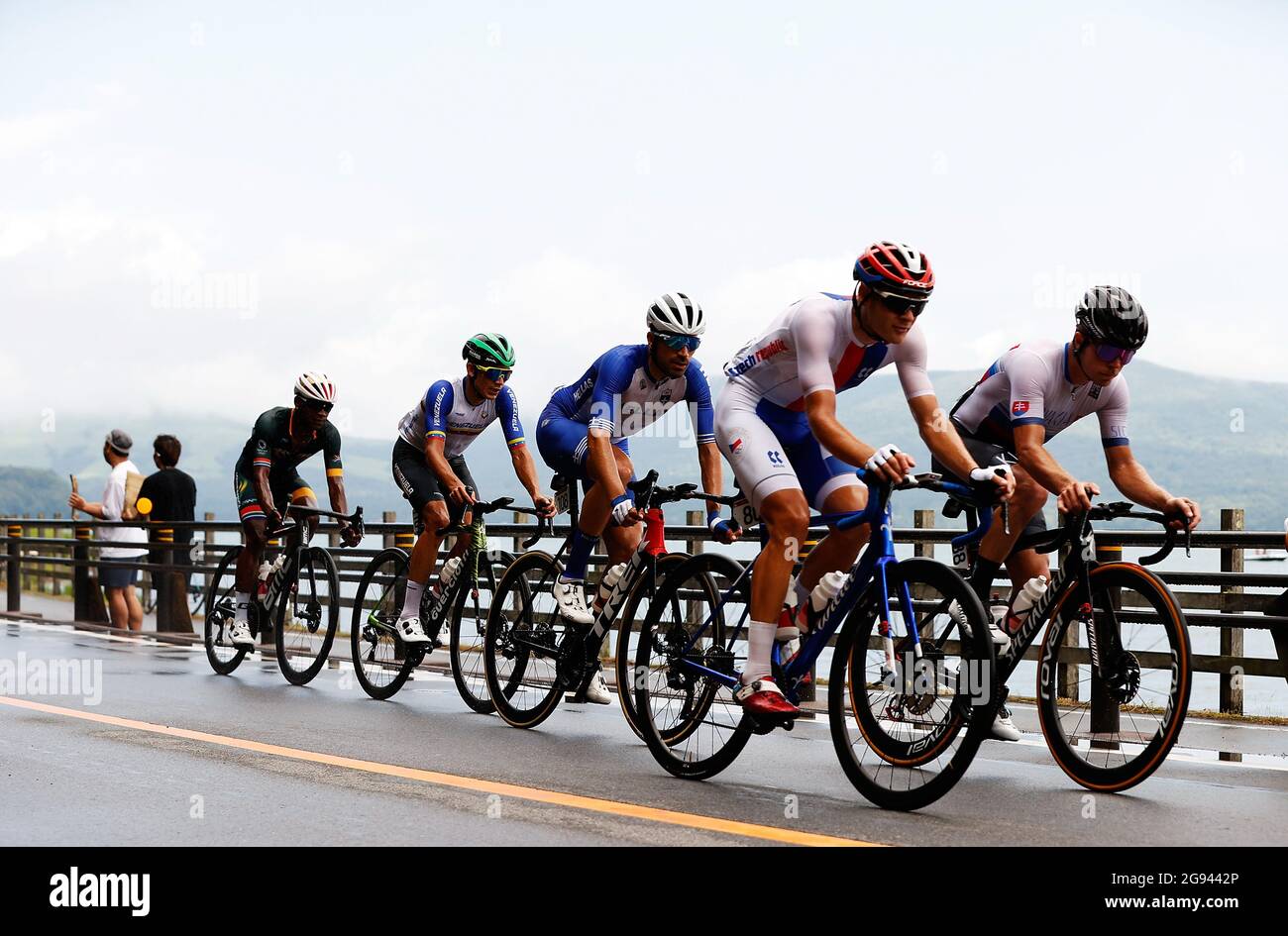 Tokyo, Japan. 24th July, 2021. Cyclists ride past Lake Yamanakako in ...