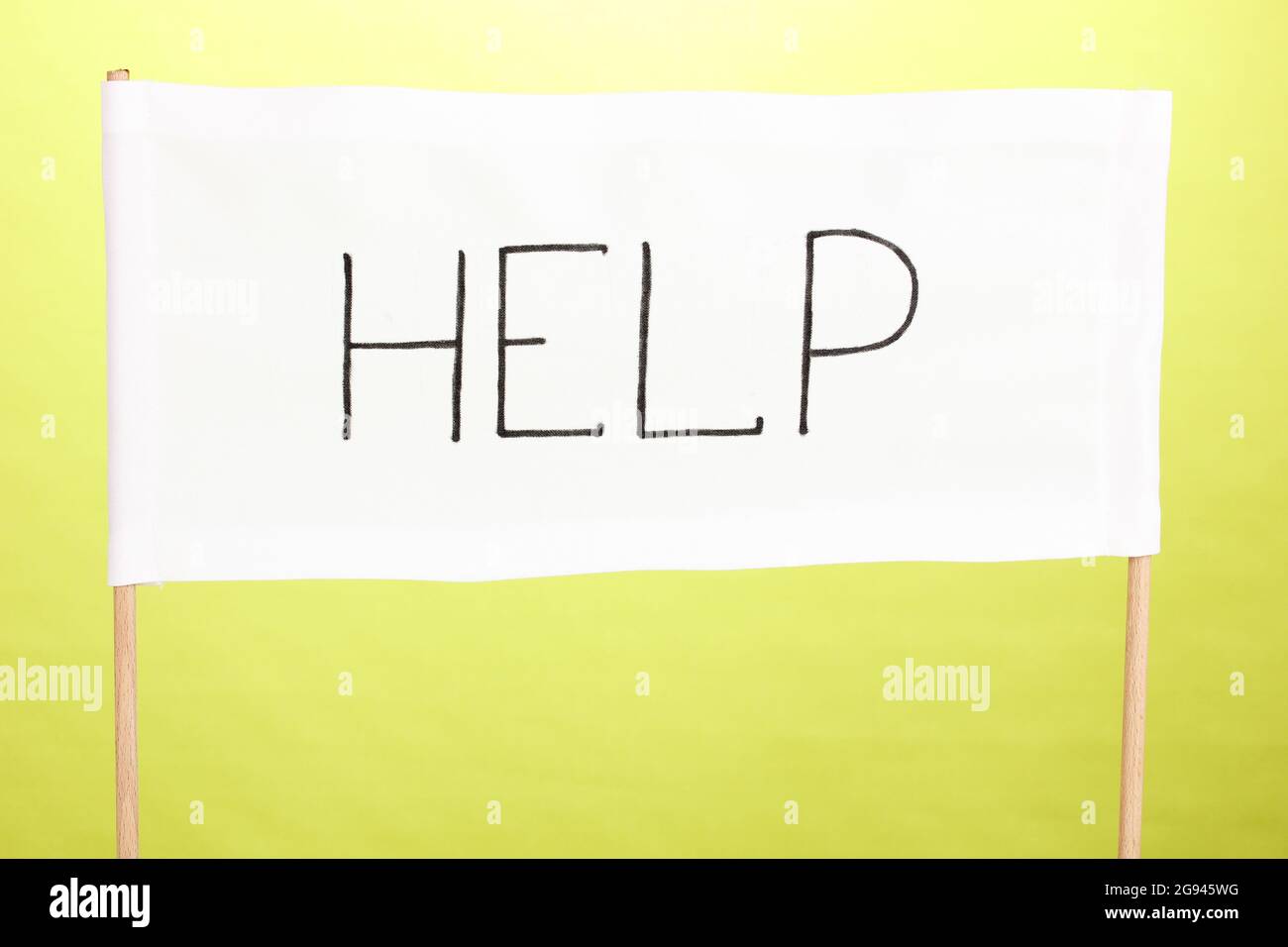 Help written on white cloth on green background Stock Photo - Alamy