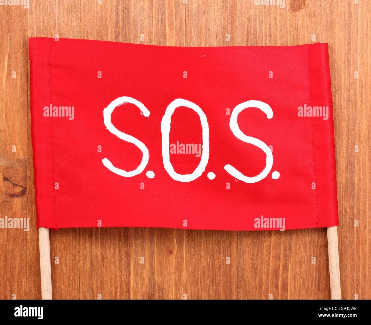 SOS signal written on red cloth on wooden background Stock Photo - Alamy