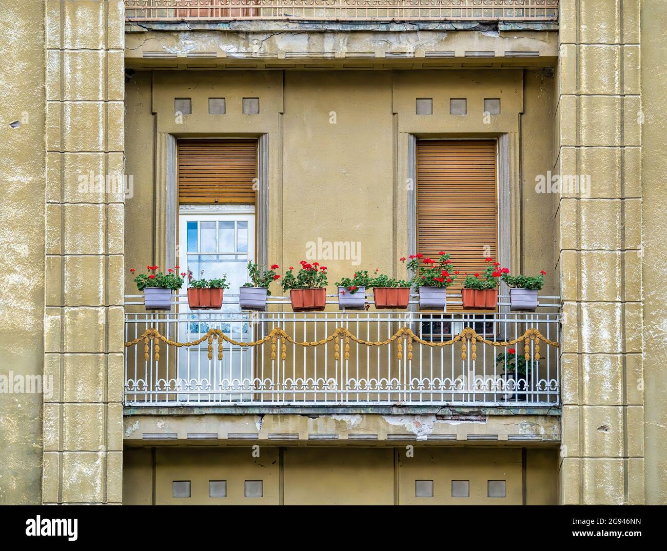 Old architectural detail of a elegant balcony decorated with flowers ...