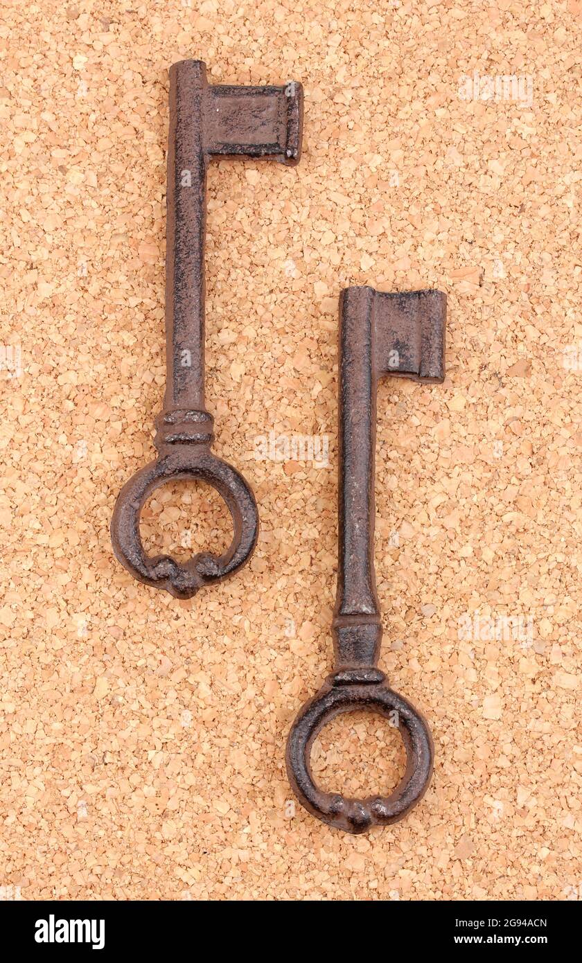 Two antique keys on cork background Stock Photo - Alamy