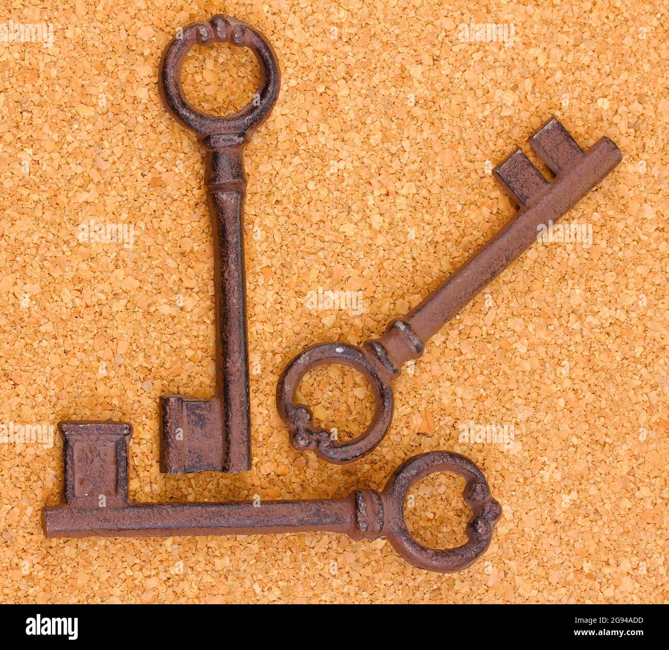 a bunch of antique keys on cork background Stock Photo - Alamy