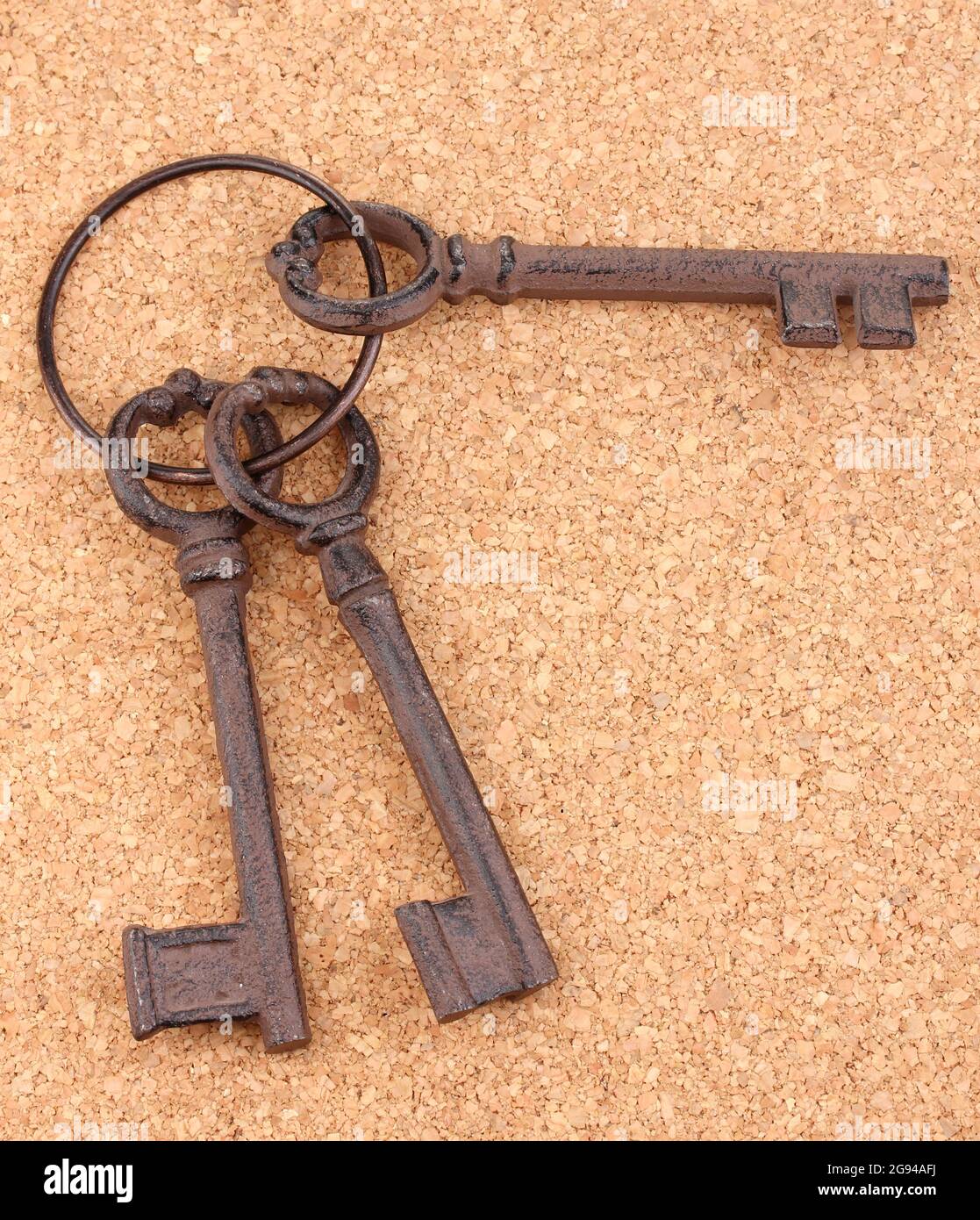 a bunch of antique keys on cork background Stock Photo - Alamy