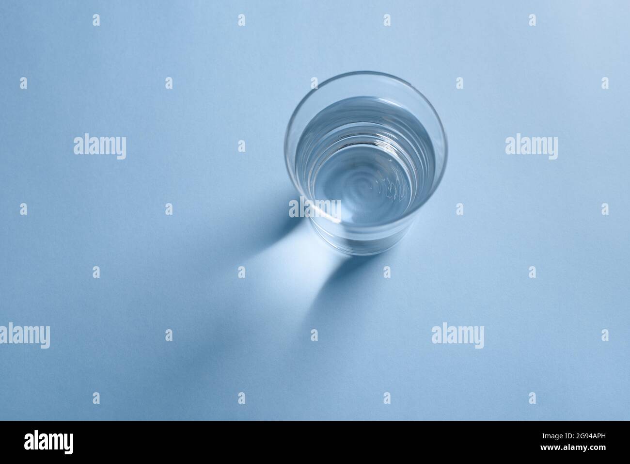 Top view of a glass of clean drinking water on blue background Stock ...