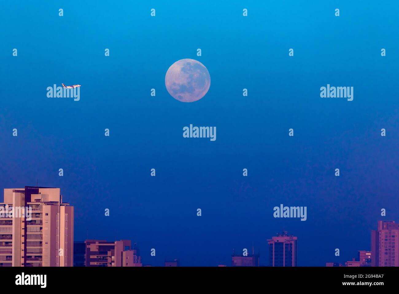 Sao Paulo, Brazil. 24th July, 2021. Airplane and Full Moon early on ...