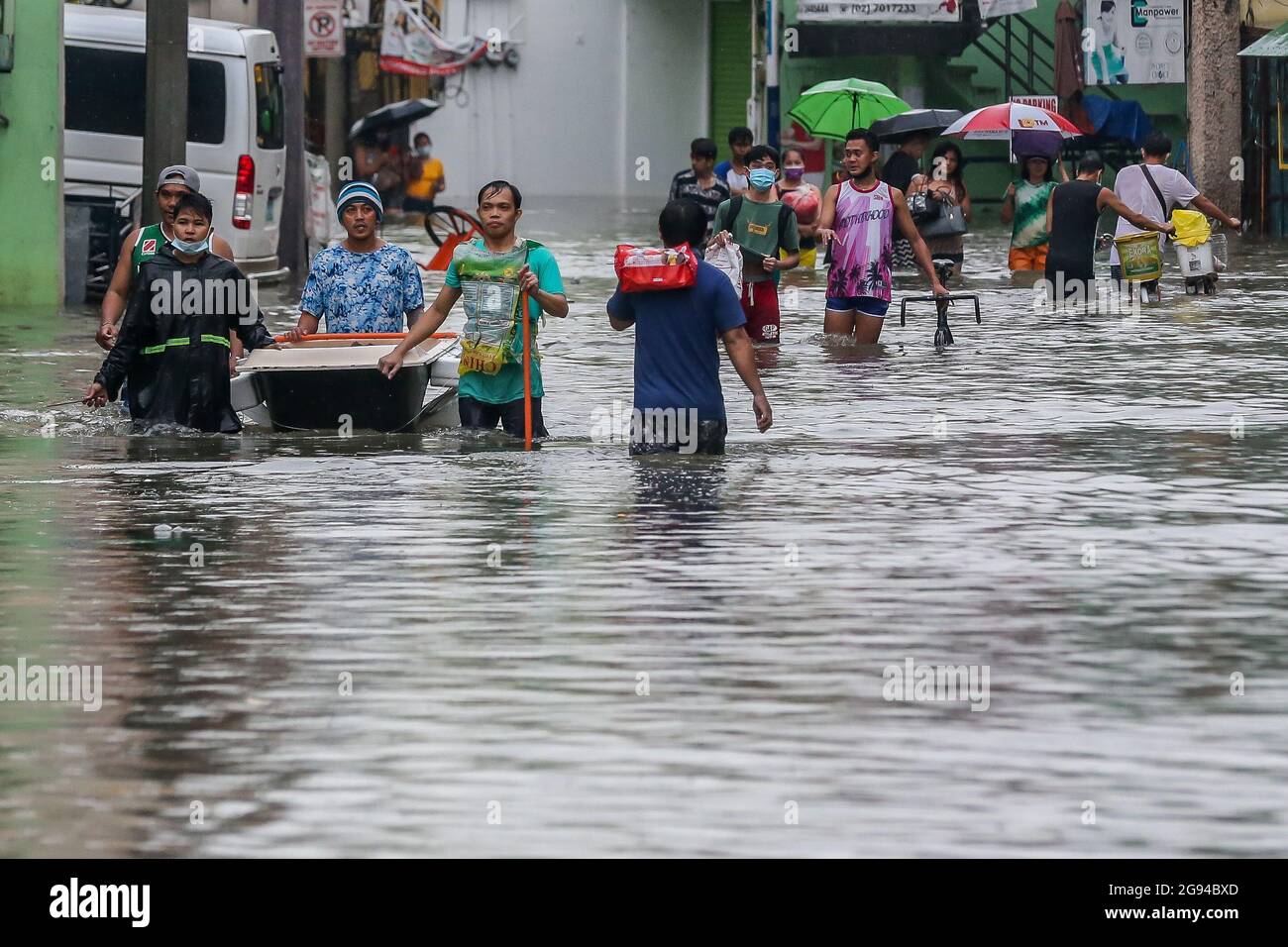 Rizal Province, Philippines. 24th July, 2021. People wade through the ...