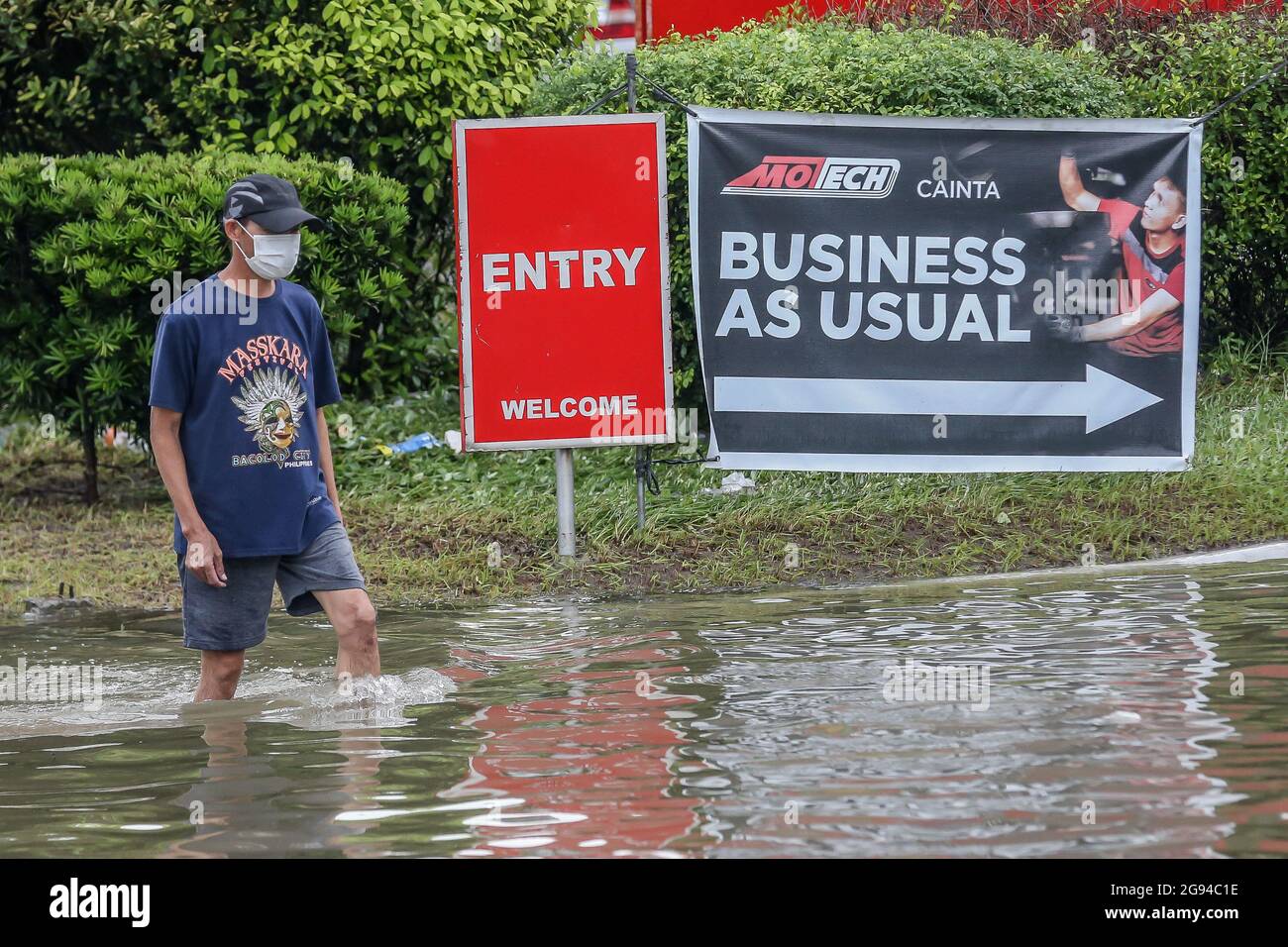 Rizal Province, Philippines. 24th July, 2021. A man wades through the ...