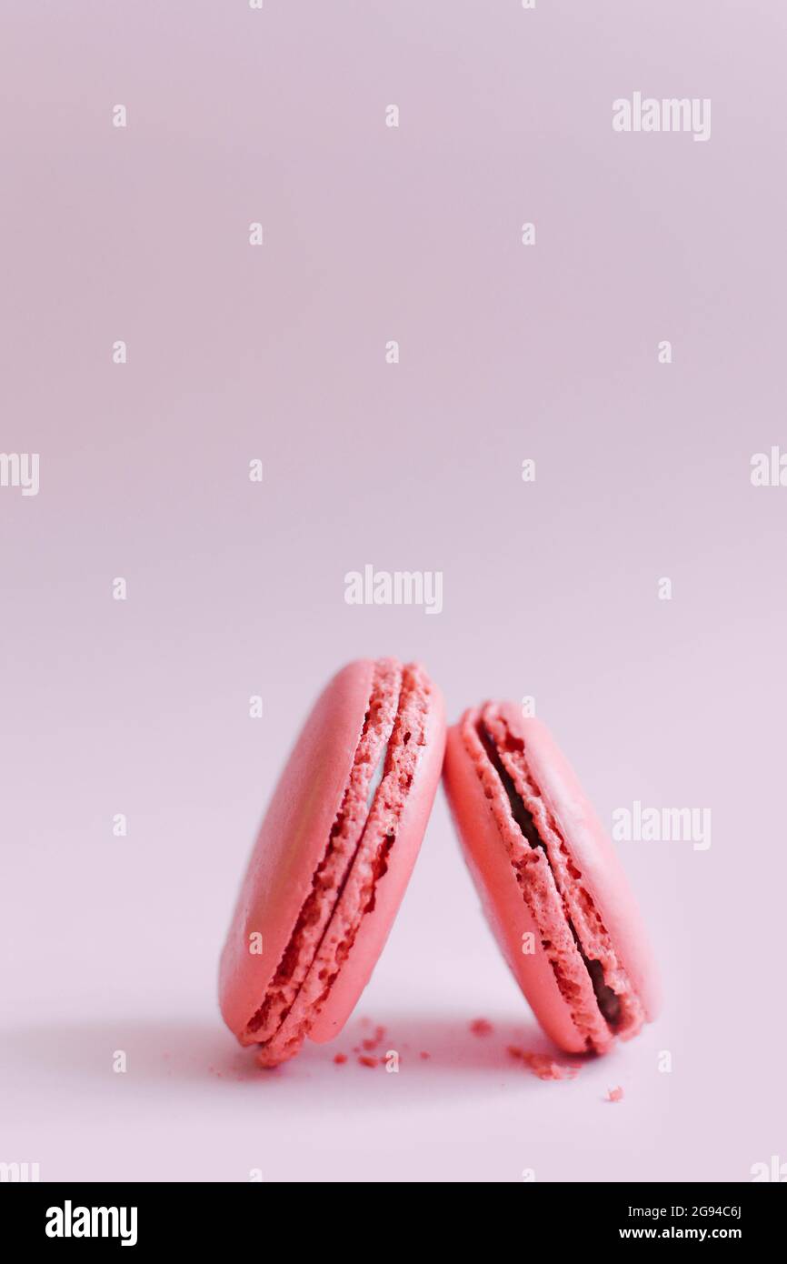 Dessert of pink macaroons stands on a single background Stock Photo - Alamy