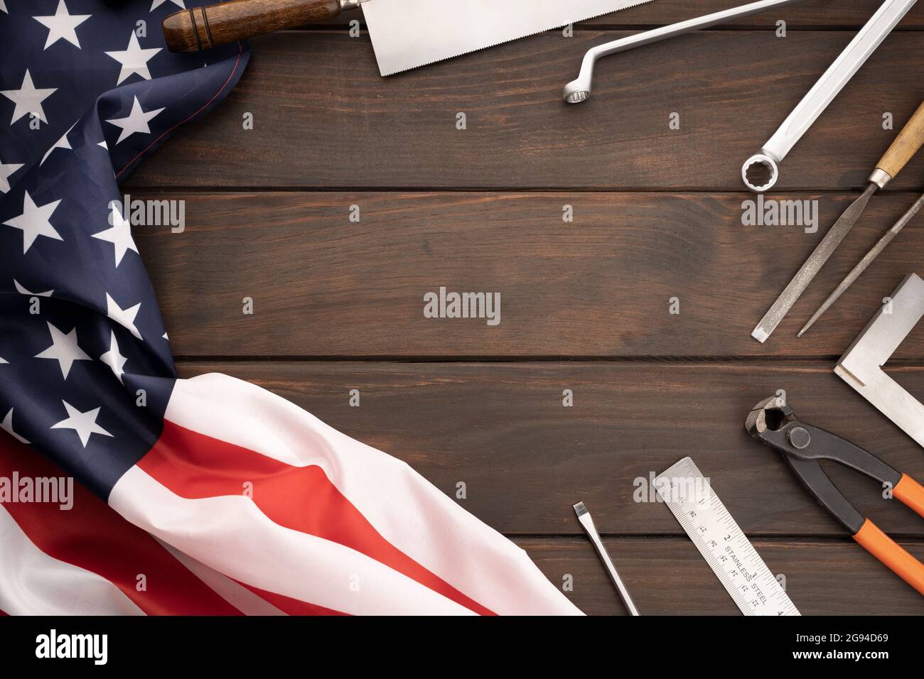Top view of american flag and work tools on wooden tabletop with copy ...