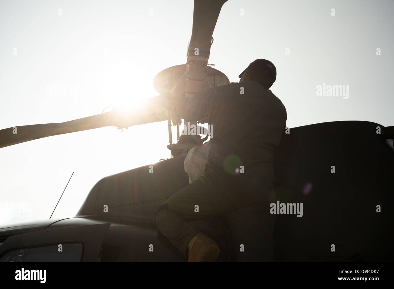 military man cleaning a helicopter against sunlight Stock Photo - Alamy