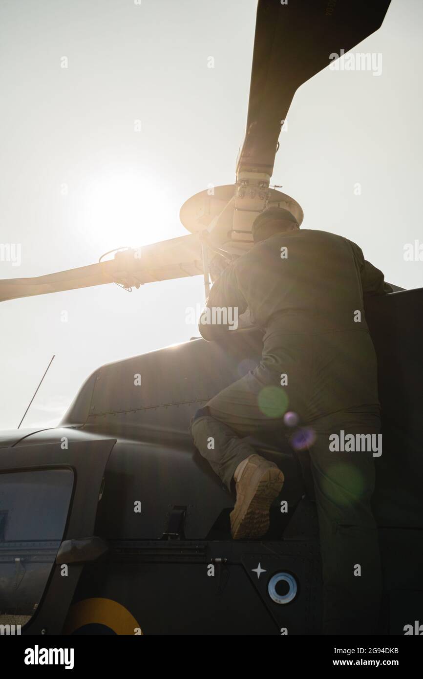 military man cleaning a helicopter against sunlight Stock Photo - Alamy