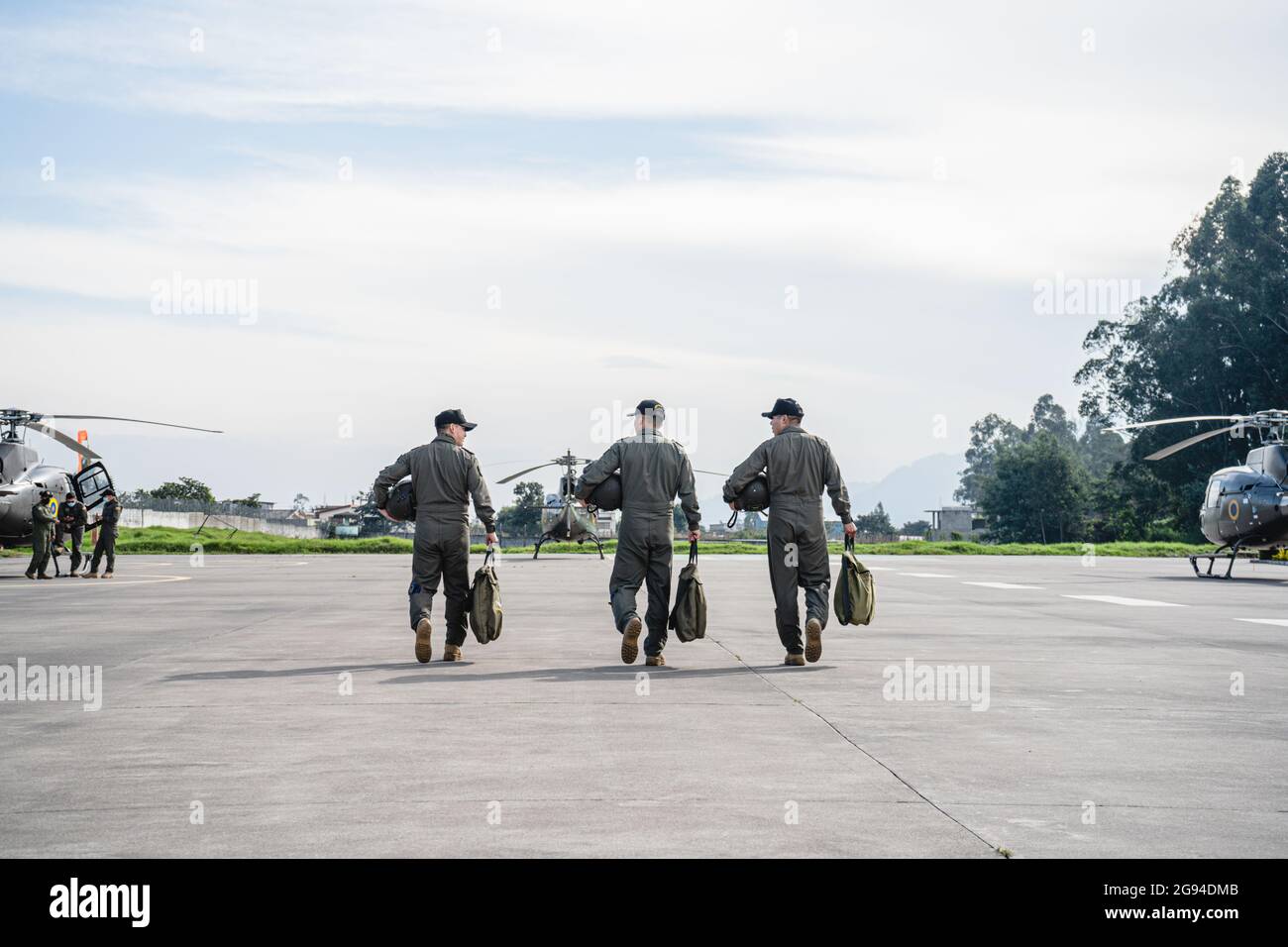 three military men walking on a runway towards the helicopters Stock ...