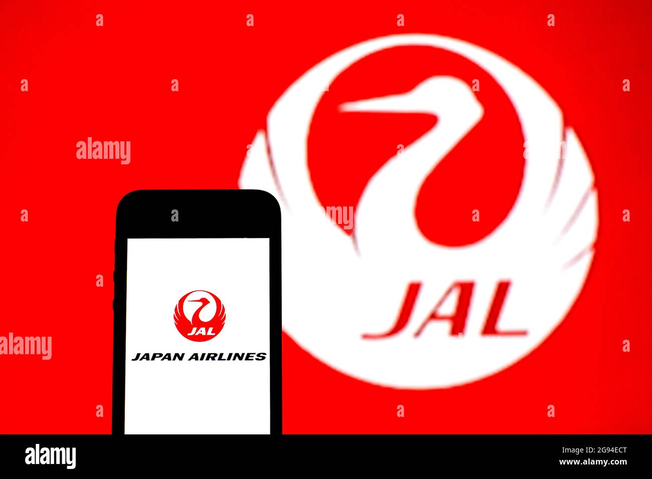 In this photo illustration a Japan Airlines logo seen displayed on a ...