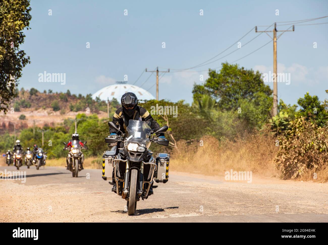 Men riding their adventure motorbikes on country road in Cambodia Stock ...