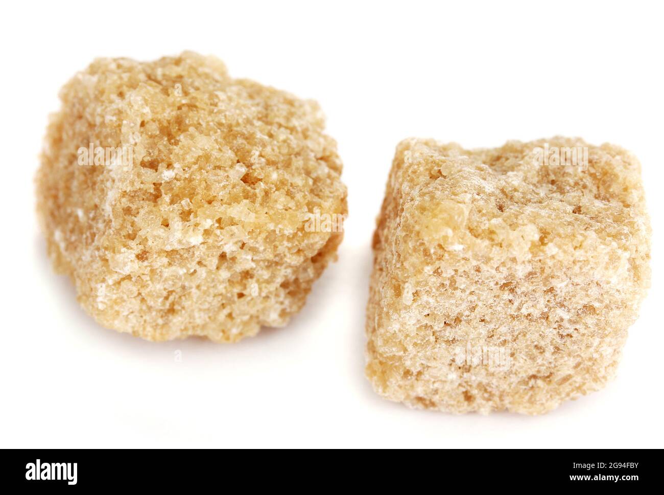 Lump brown cane sugar cubes isolated on white Stock Photo - Alamy