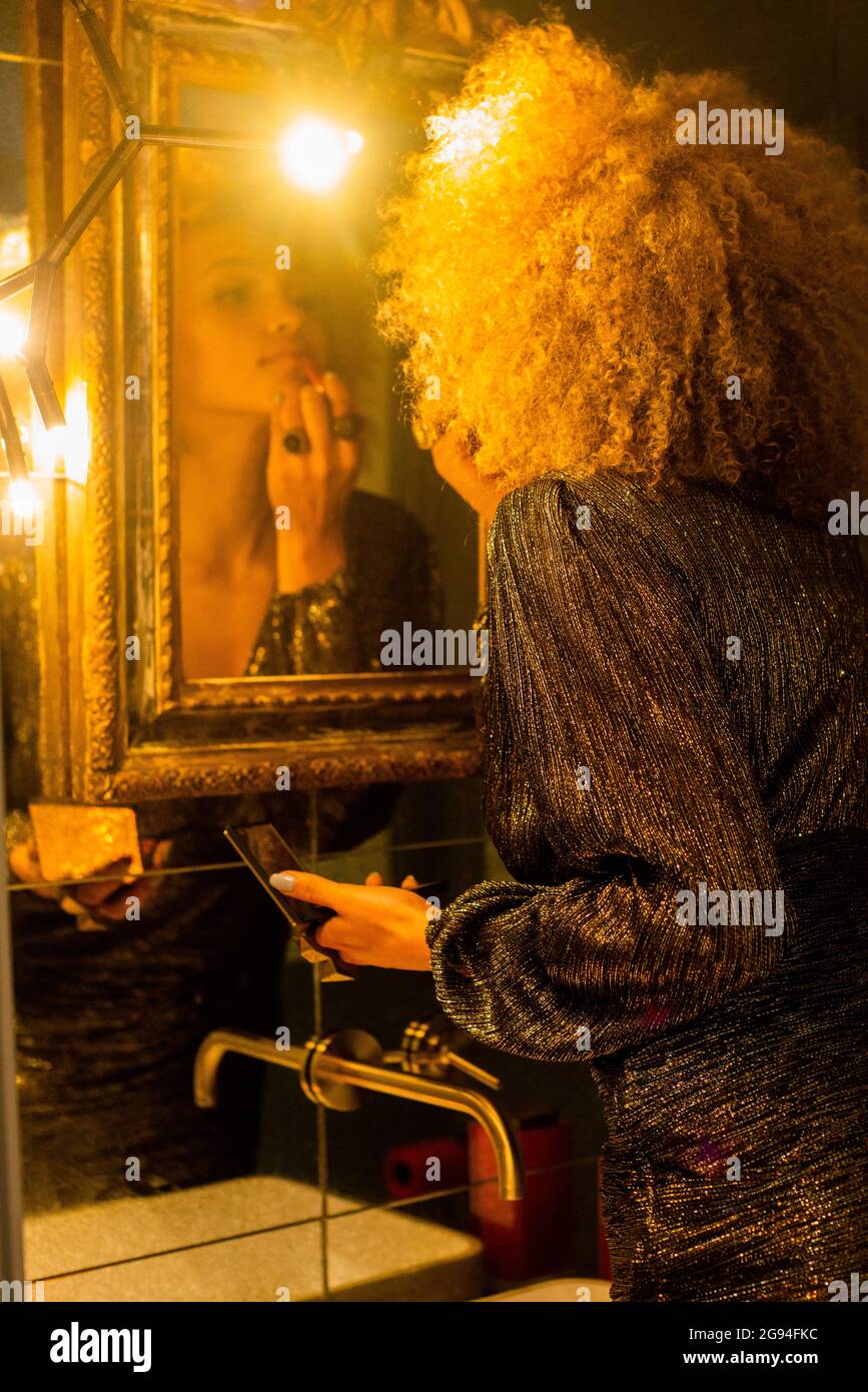 Golden Reflection in bathroom mirror Stock Photo - Alamy