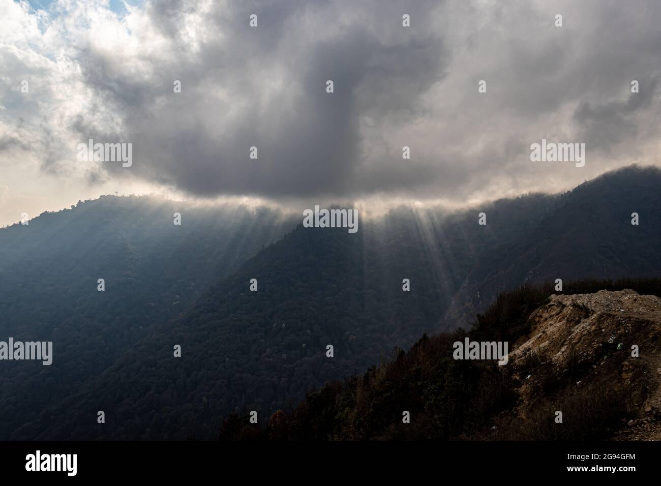 mountain range with sun ray beams and heavy cloud overcast at day Stock ...