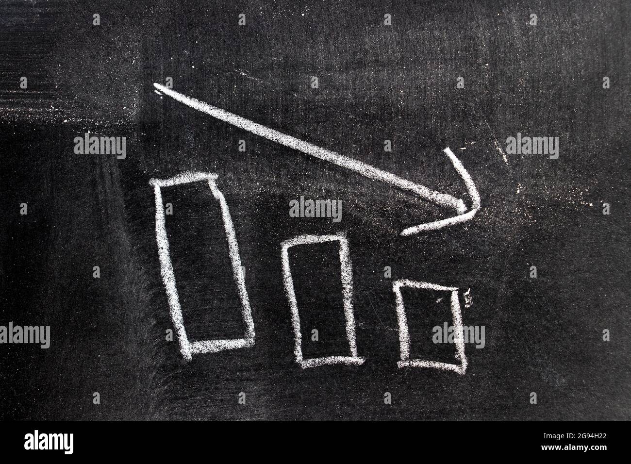 White chalk hand drawing in bar chart with downtrend arrow shape on ...