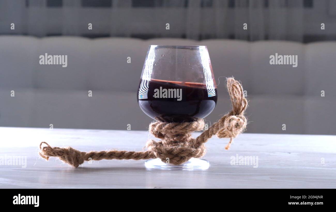The wine glass is tied with a rope. The concept of alcohol dependence ...