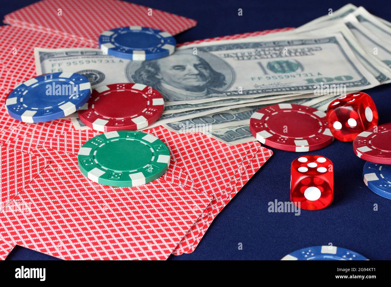 The blue poker table with poker chips, playing cards, dice and dollars ...