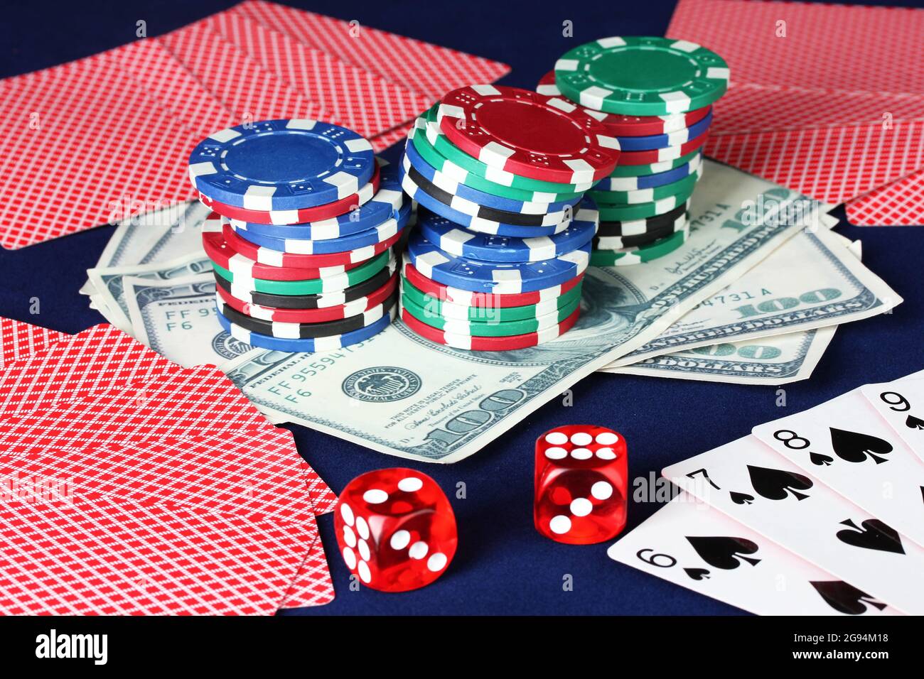 The blue poker table with cigars, poker chips, playing cards and ...