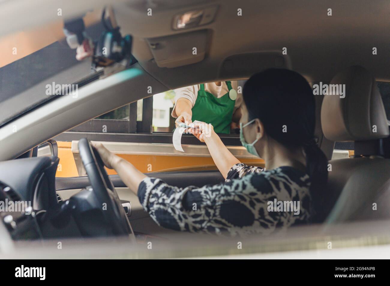 Woman customer paying bills with credit card at Starbuck Cafe drive ...
