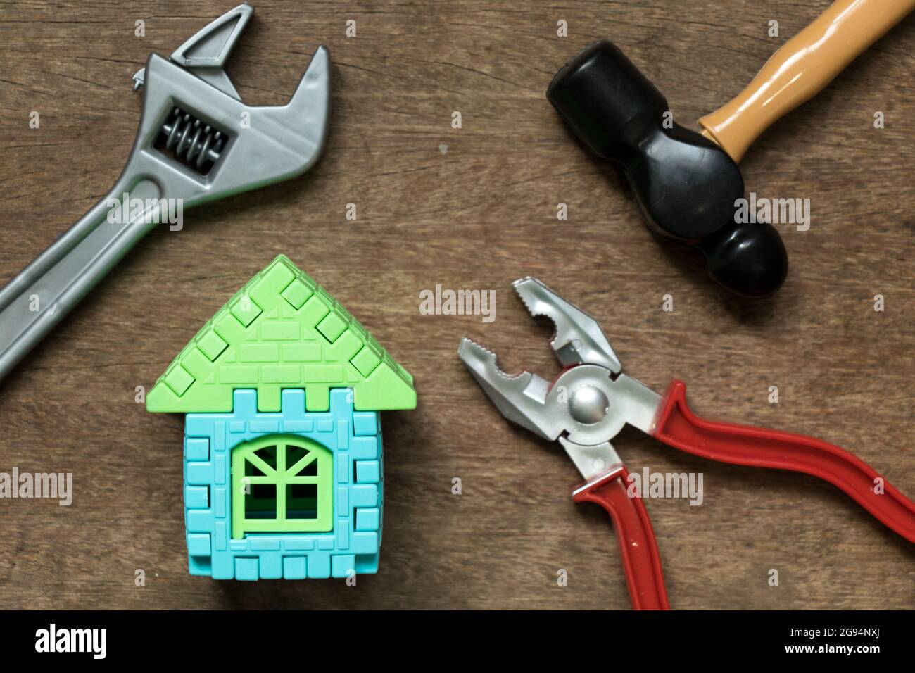 Home model object with toy equipment tool on wood background (Concept ...
