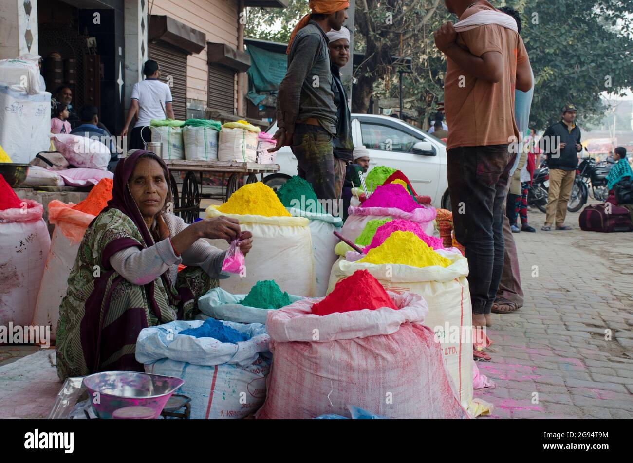 An old woman is selling colors on the day of color festival in India ...