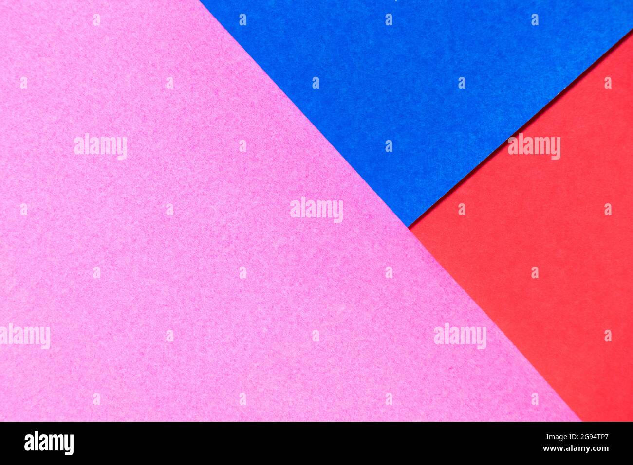 Pink, red and blue color paper display as abstract blank background ...