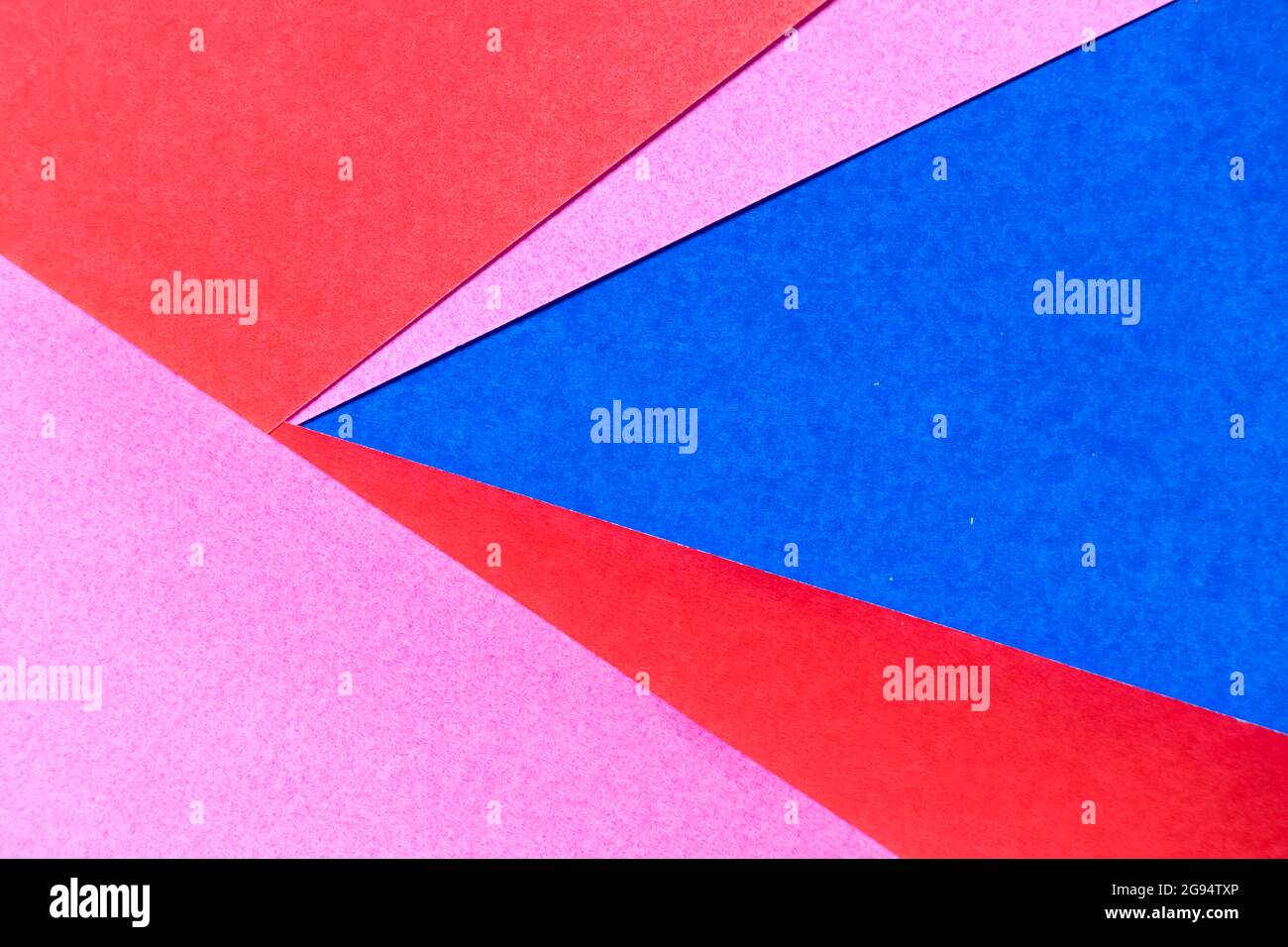 Pink, red and blue color paper display as abstract blank background ...