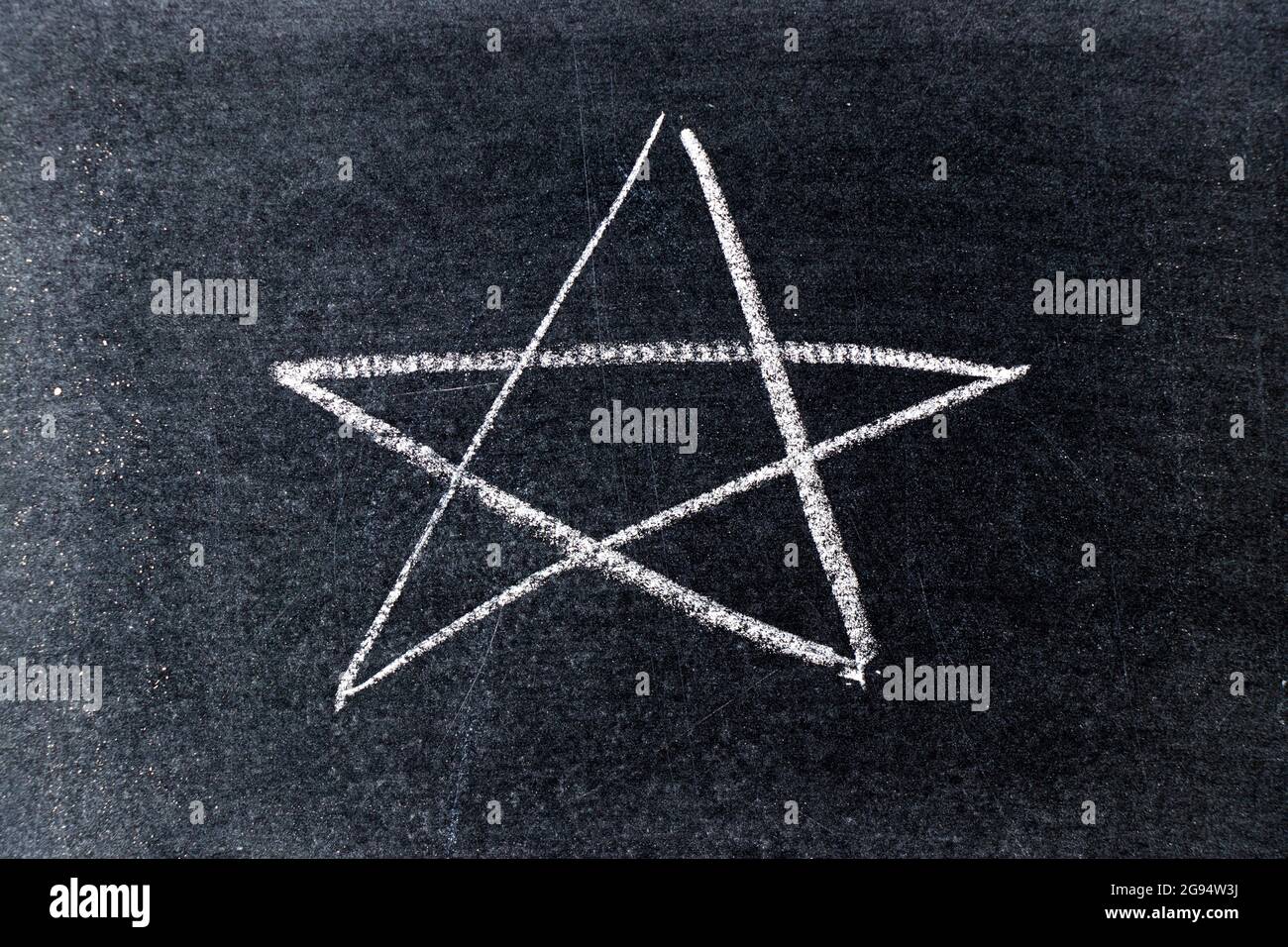 White chalk drawing in star shape on black board background Stock Photo ...
