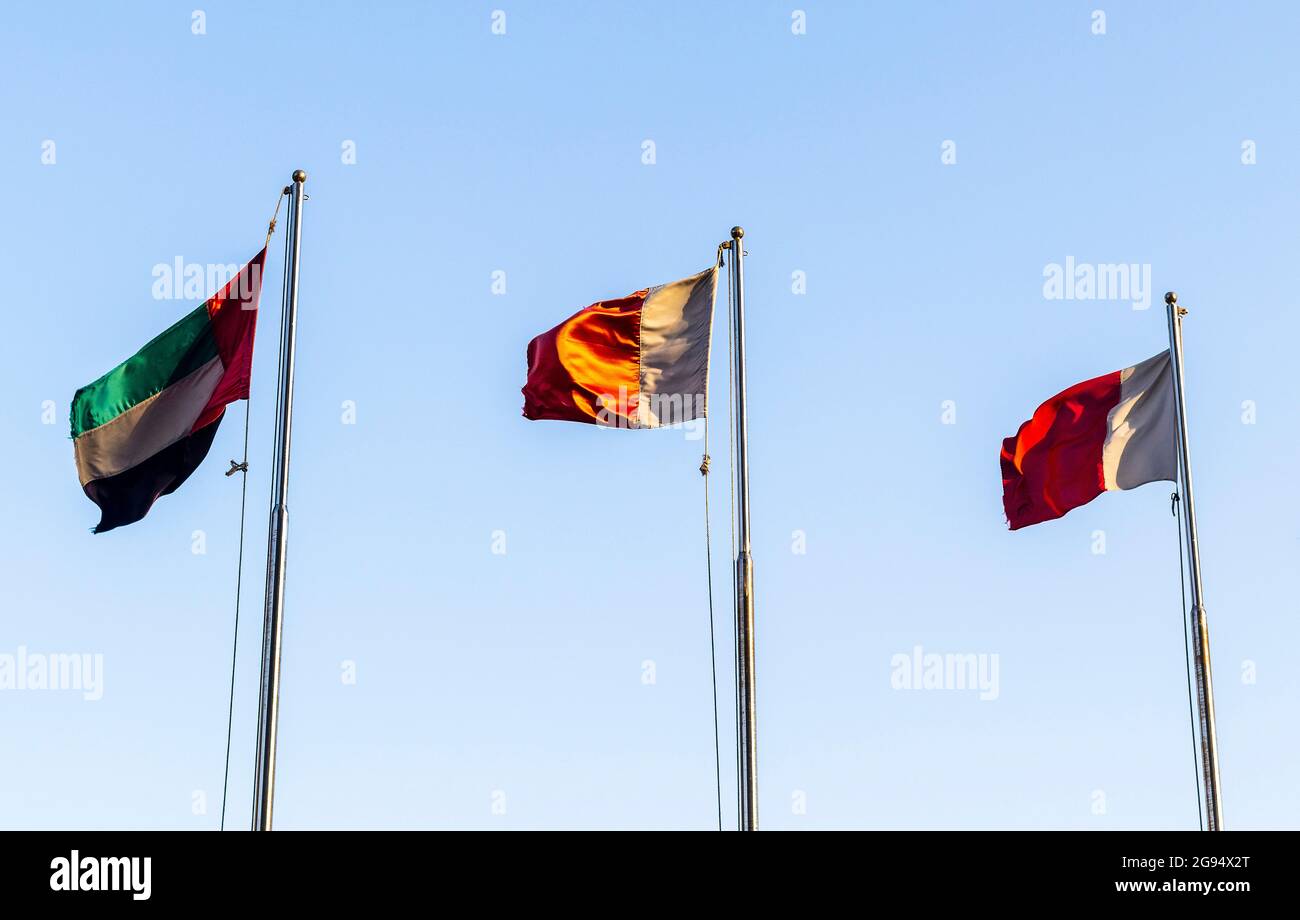 Dubai,UAE - 07.22.2021 UAE flag floats with red and white flags with ...
