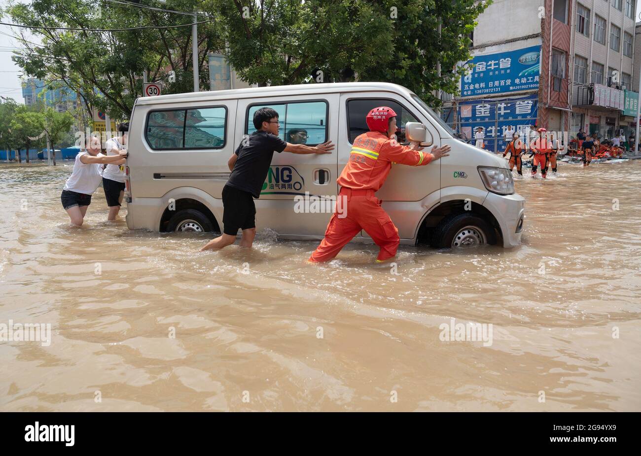 Zhengzhou, China's Henan Province. 24th July, 2021. Rescuers help ...