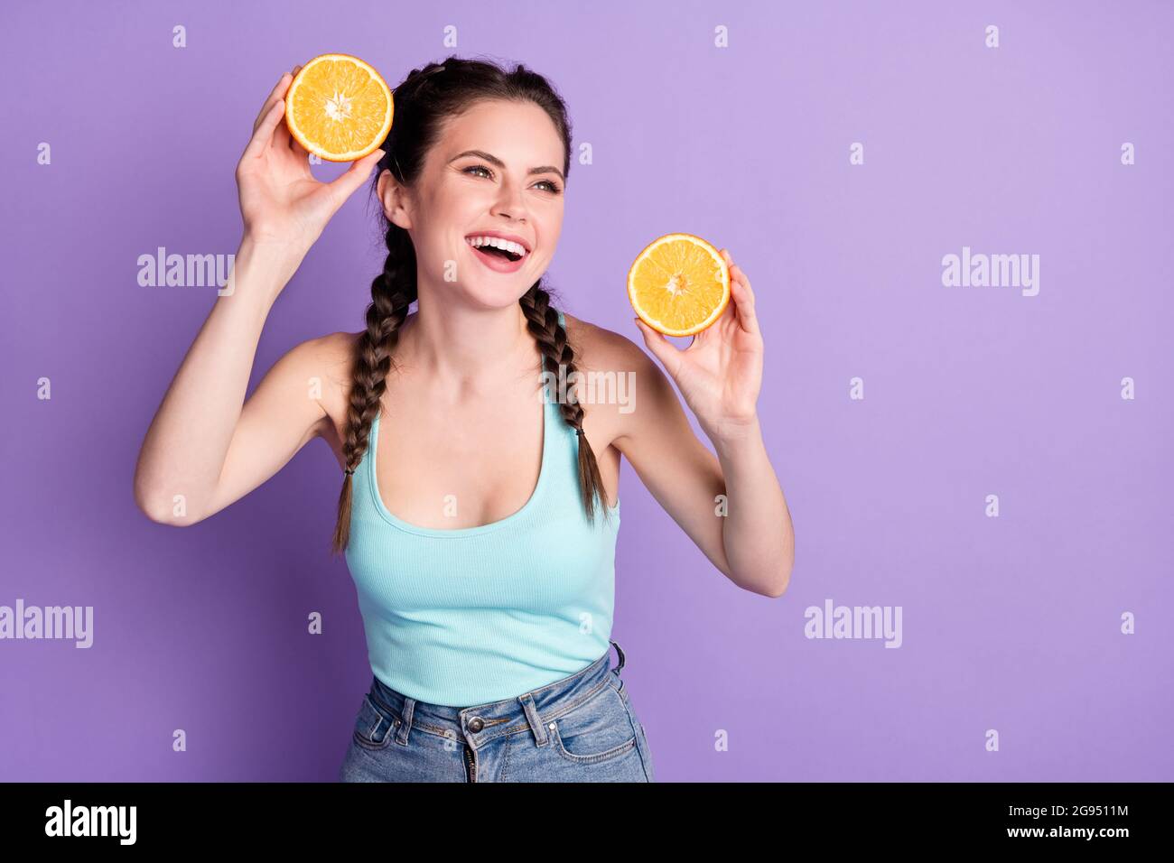 Portrait of attractive cheerful dreamy girl dancing with slices orange ...