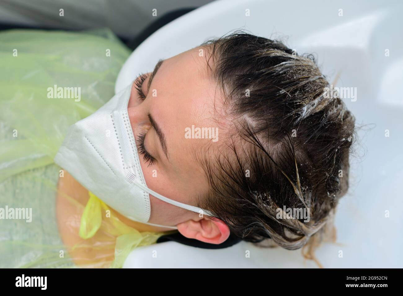 Applying conditioner after shampoo, hair care in the salon, balayage ...