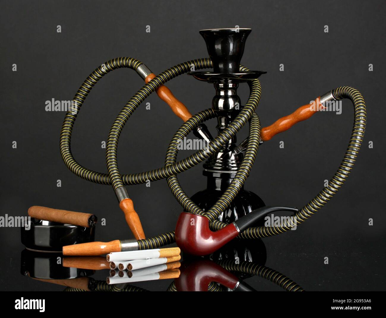 Smoking tools - a hookah, cigar, cigarette and pipe isolated on black ...