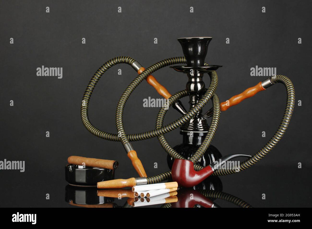 Smoking tools - a hookah, cigar, cigarette and pipe isolated on black ...