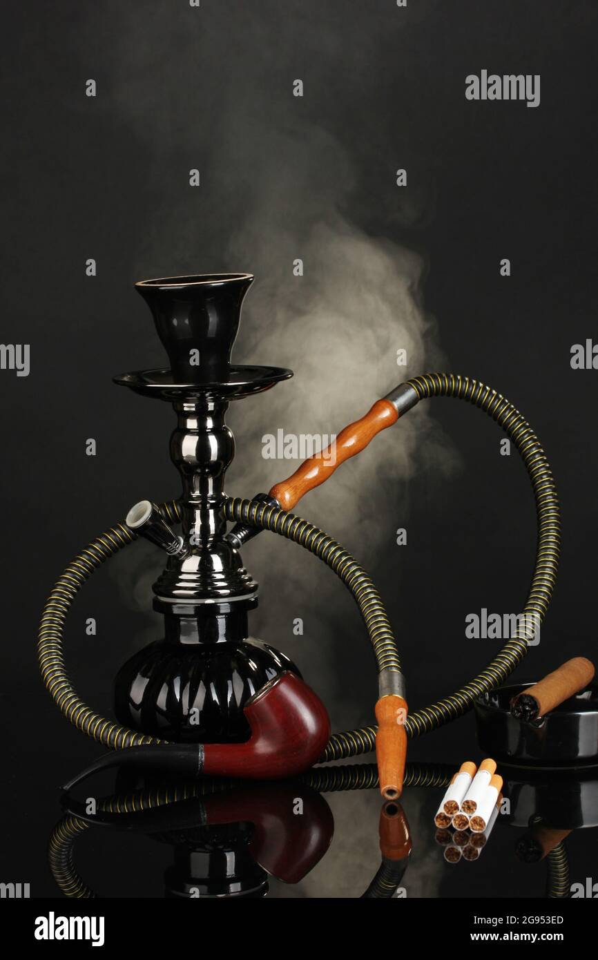 Smoking tools - a hookah, cigar, cigarette and pipe on black background ...