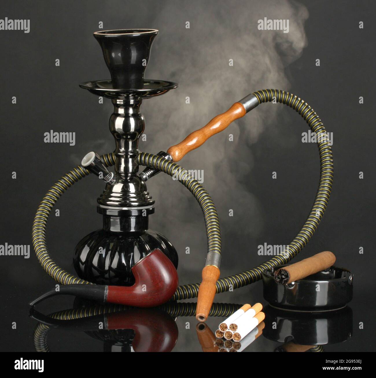 Smoking tools - a hookah, cigar, cigarette and pipe on black background ...