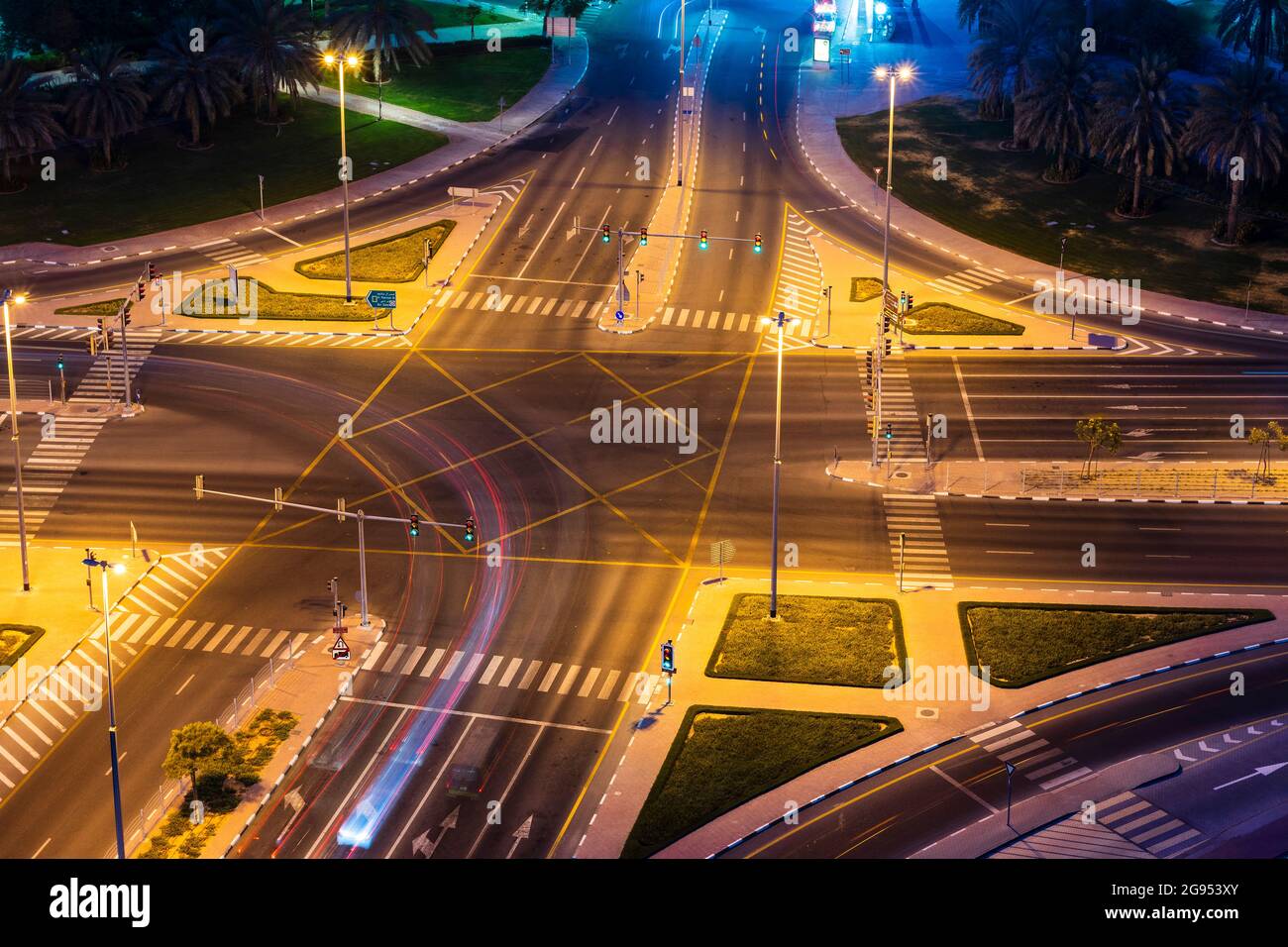 Cross road junction with light trails from cars Stock Photo - Alamy