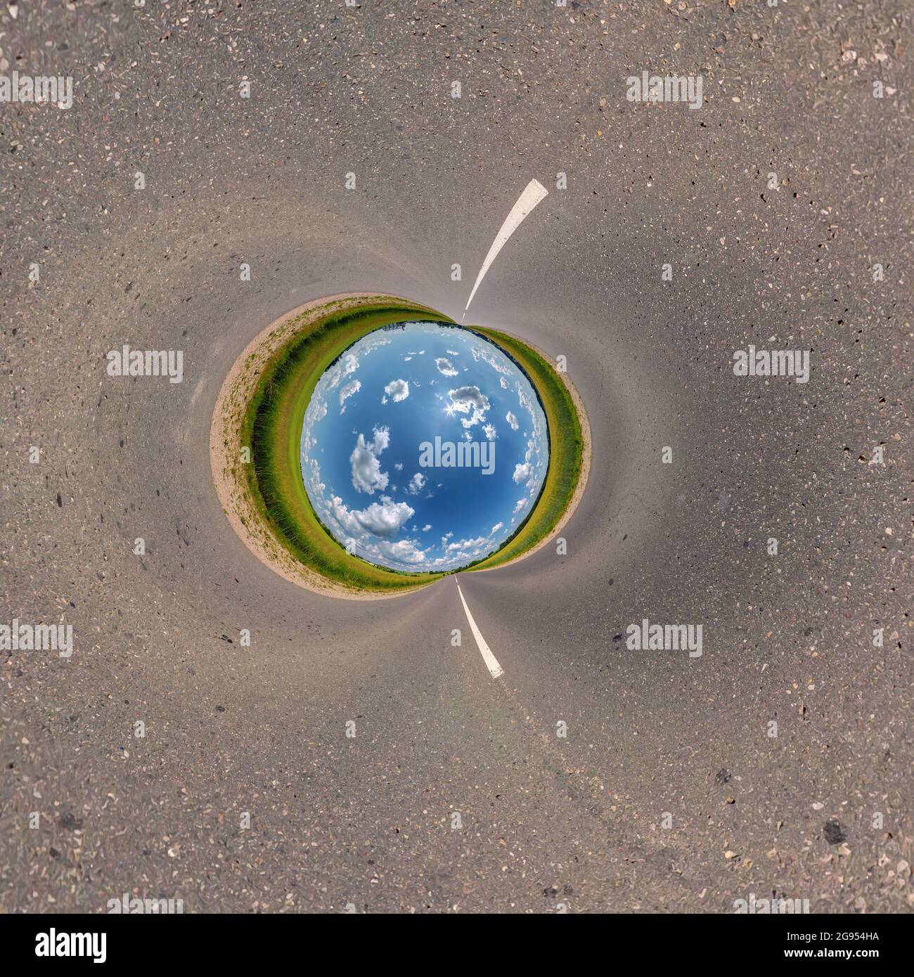 blue sky ball in middle of swirling asphalt road or field. Inversion of ...