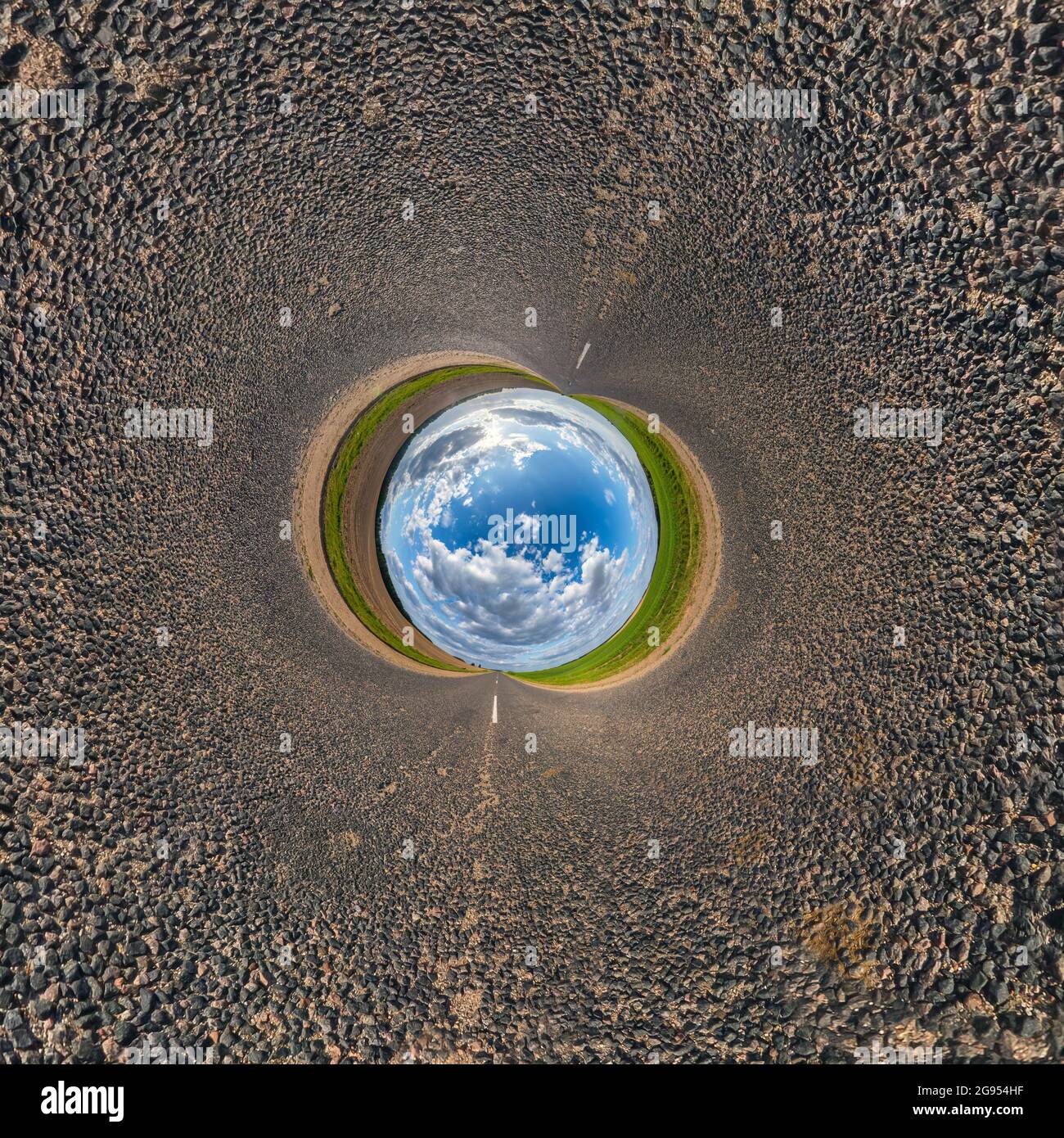 blue sky ball in middle of swirling asphalt road or field. Inversion of ...