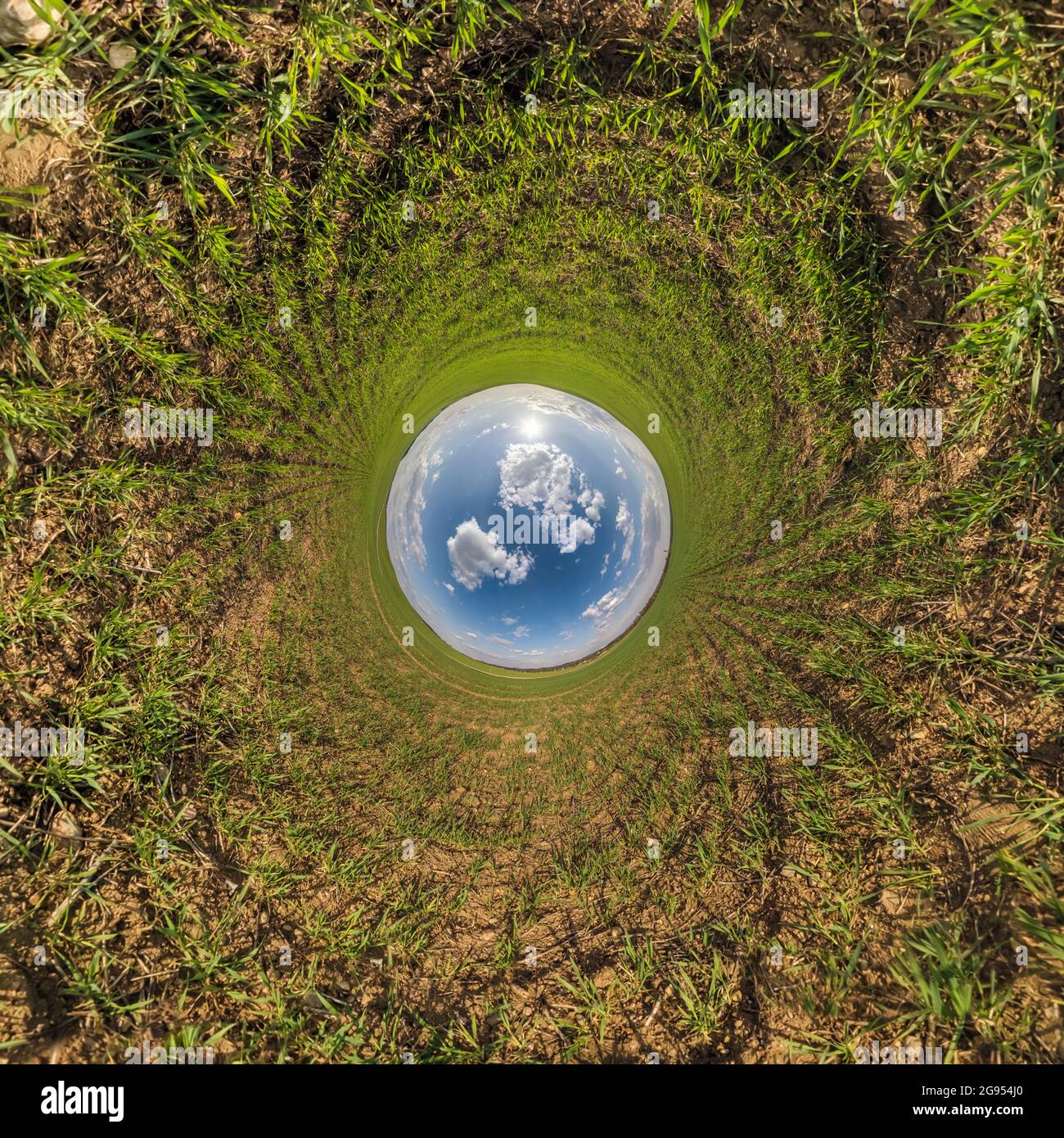 blue sky ball in middle of swirling asphalt road or field. Inversion of ...