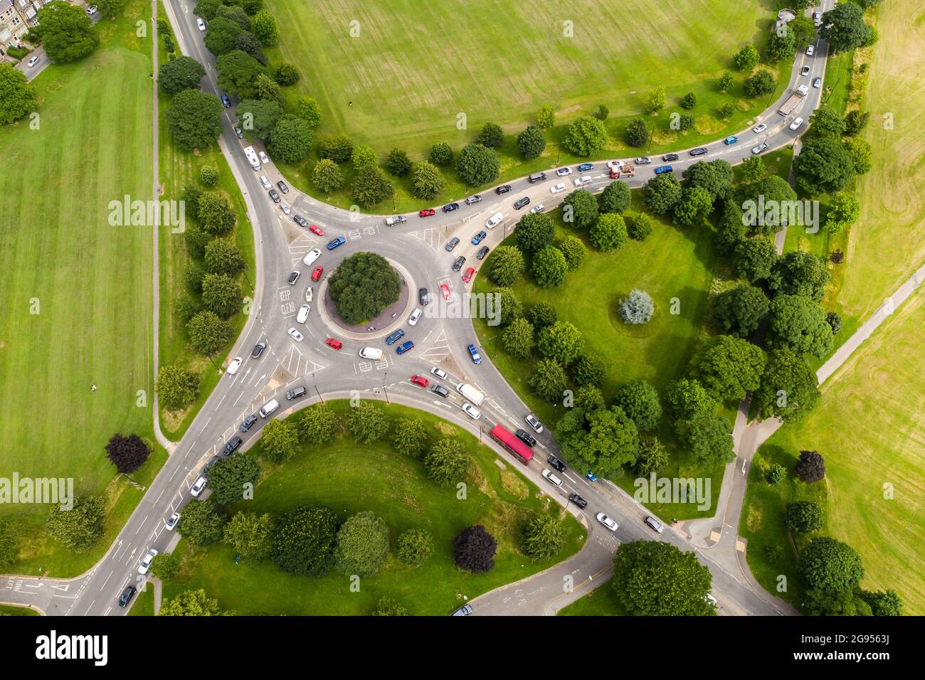 Aerial view of a busy countryside road roundabout at rush hour with ...