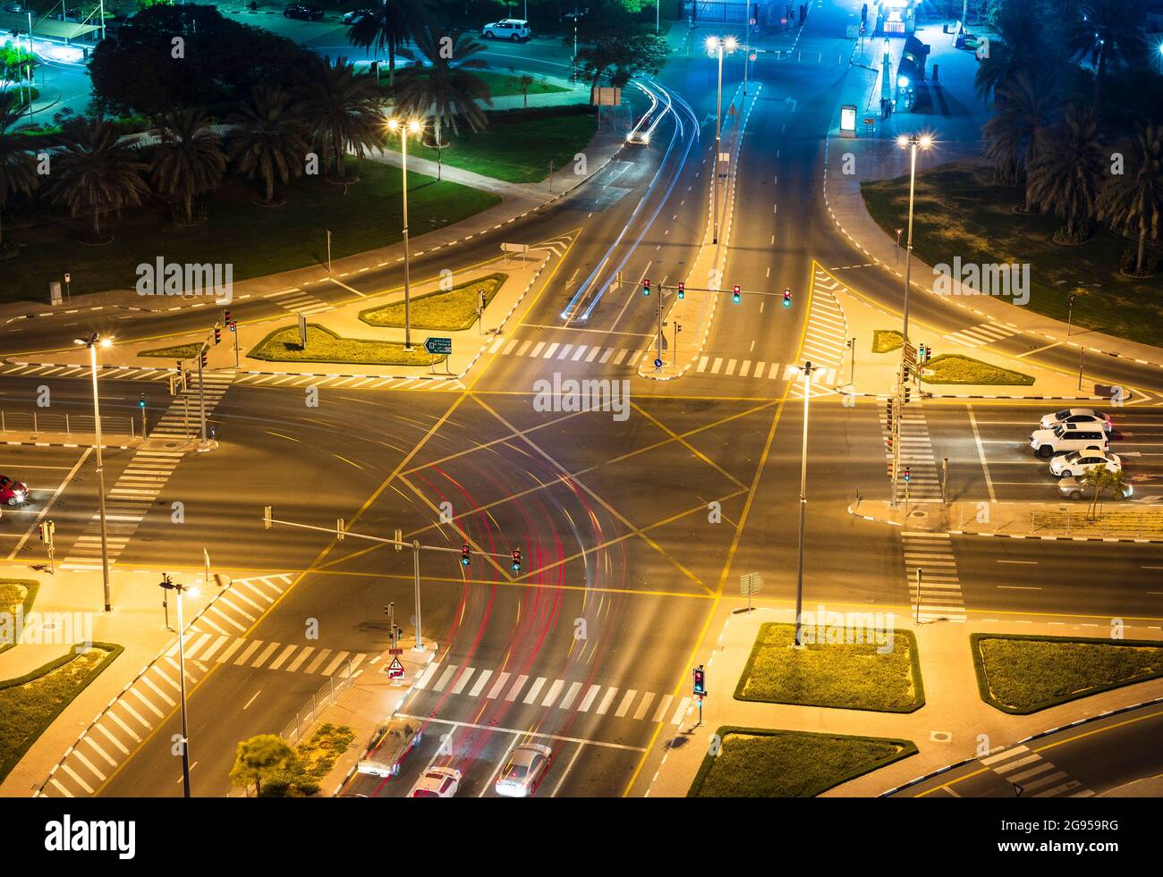 Cross road junction with light trails from cars Stock Photo - Alamy